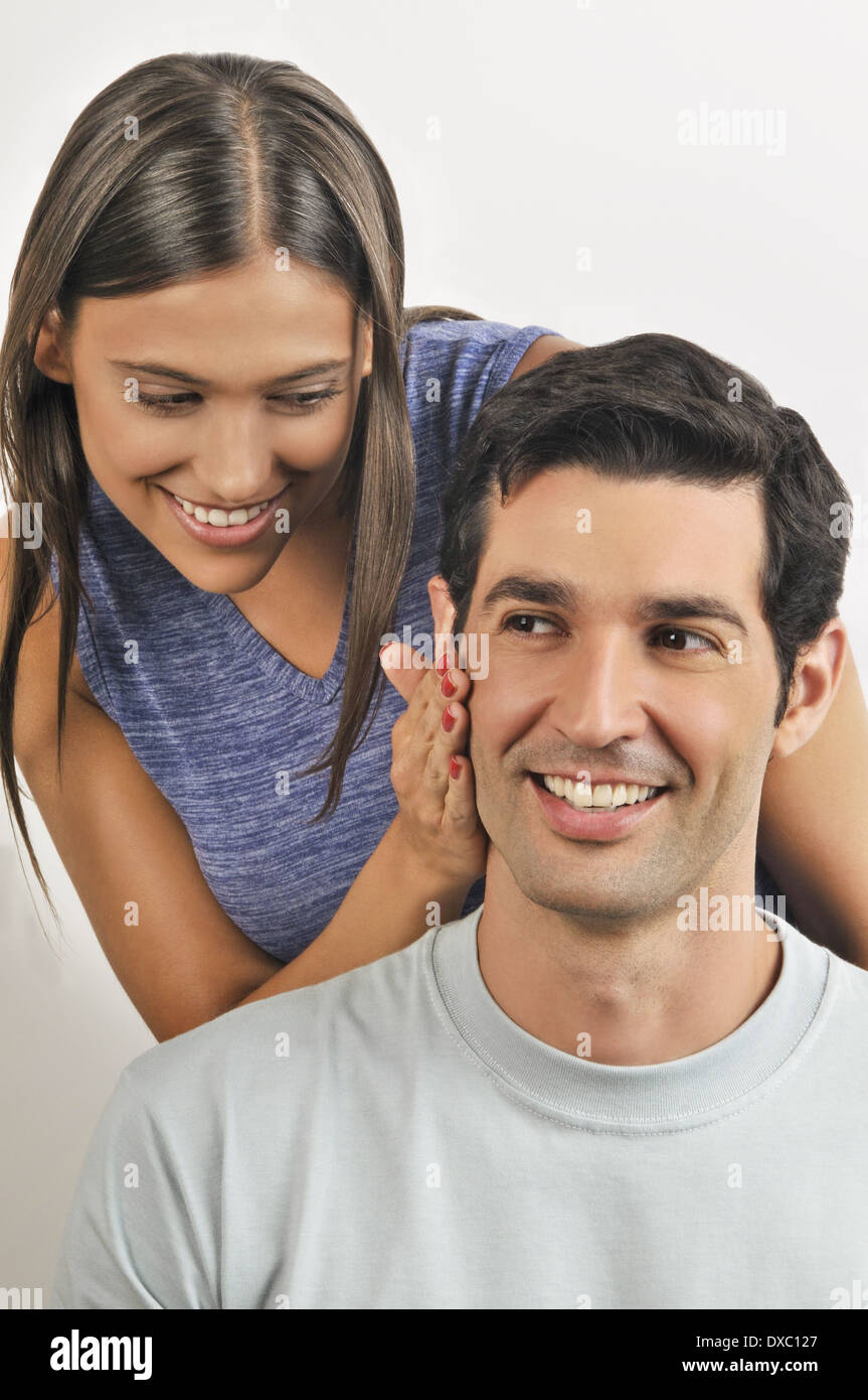 Female young adult touching man's cheek Stock Photo - Alamy