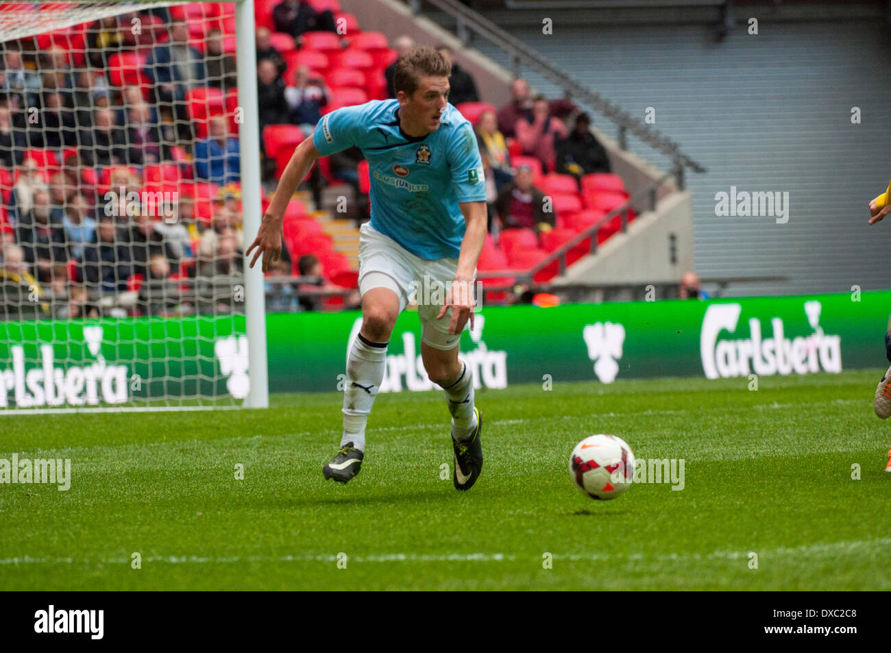 Cambridge United FC defencer eyes up a long pass, during the FA Trophy ...