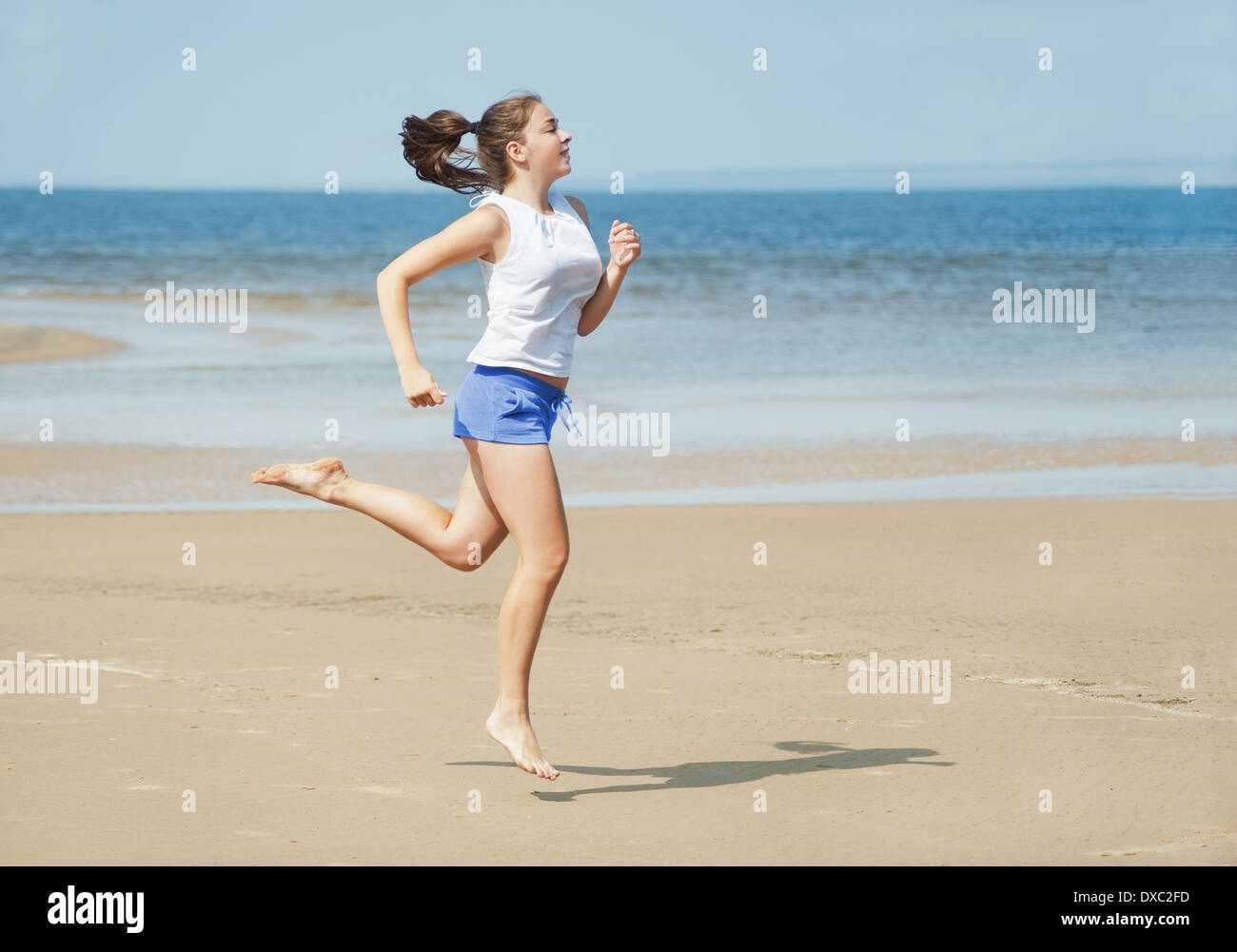 Female running on beach hi-res stock photography and images - Alamy