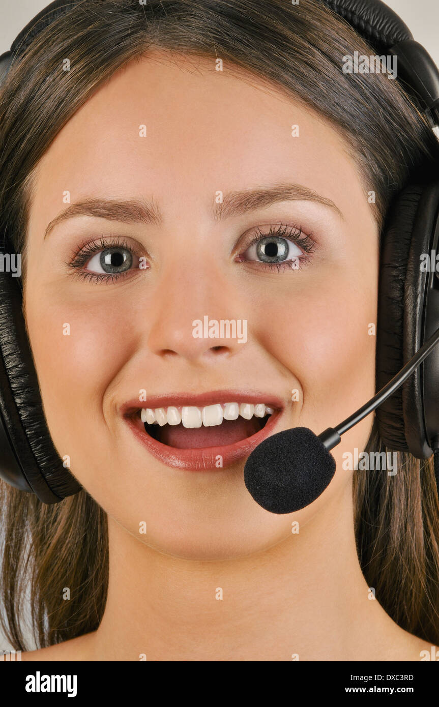 Female young adult with microphone headset Stock Photo - Alamy