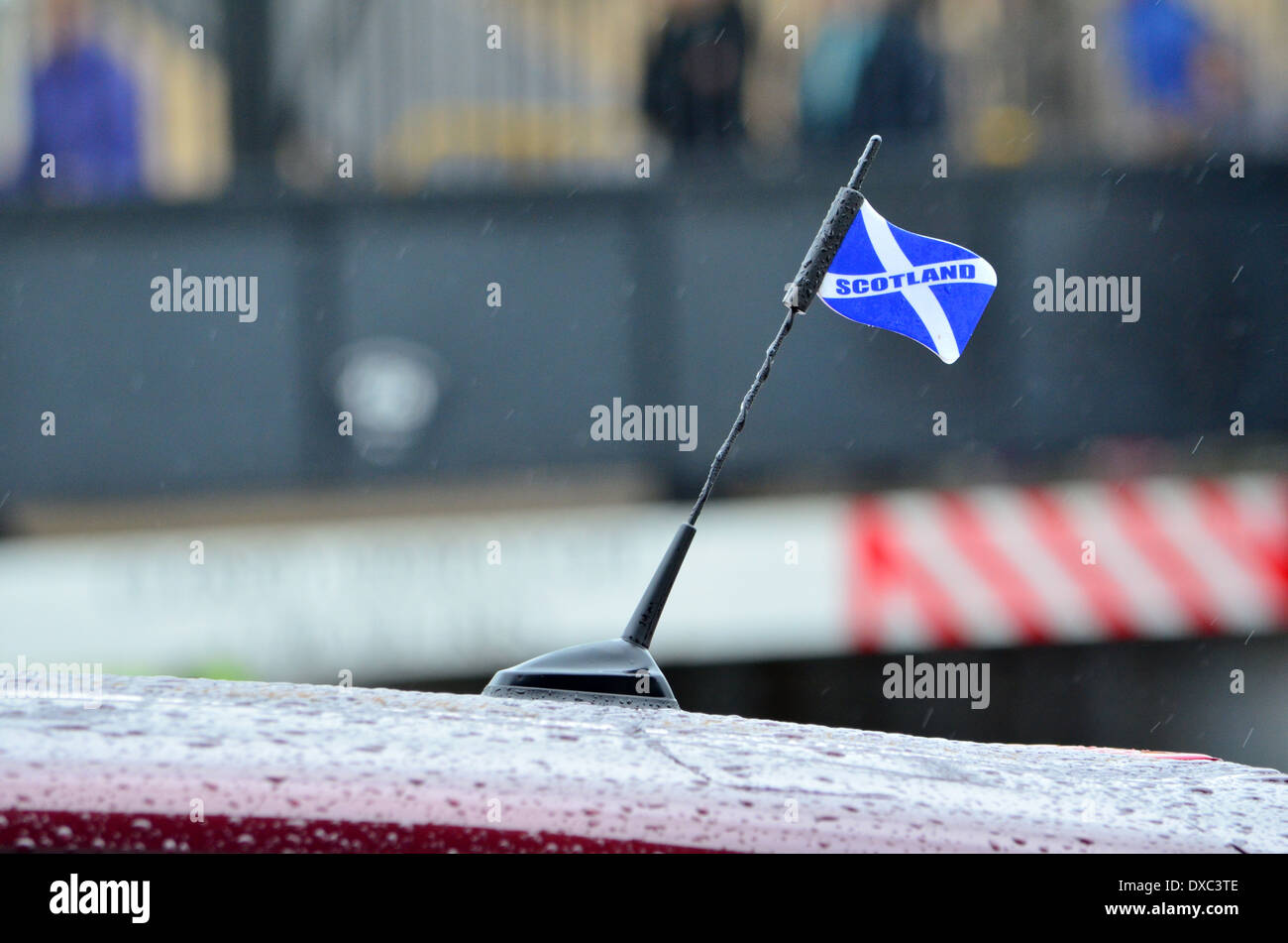 Scottish flag in the rain, on car aerial Stock Photo - Alamy