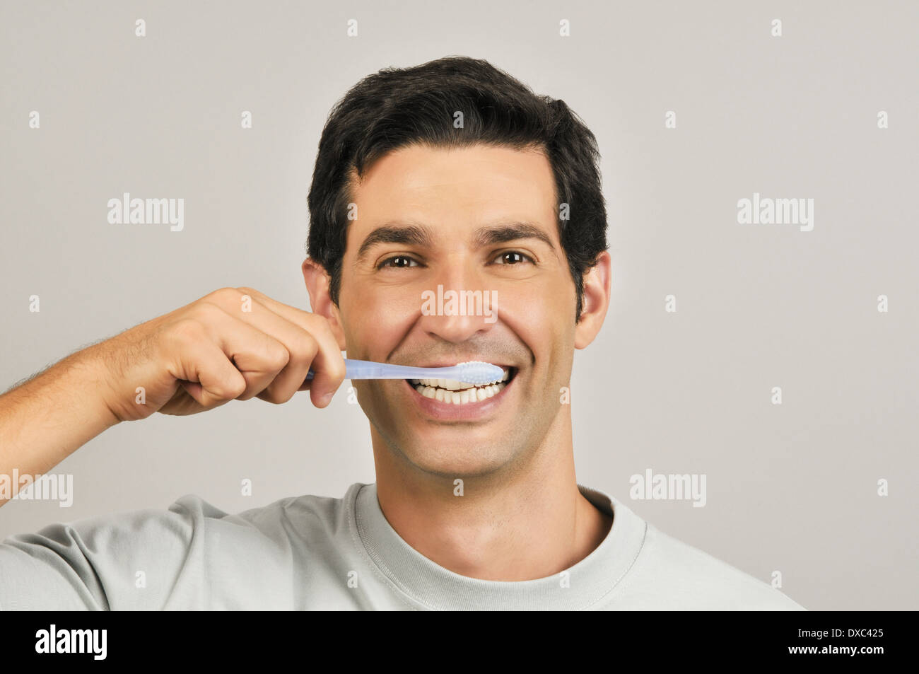 Young male adult brushing teeth Stock Photo - Alamy