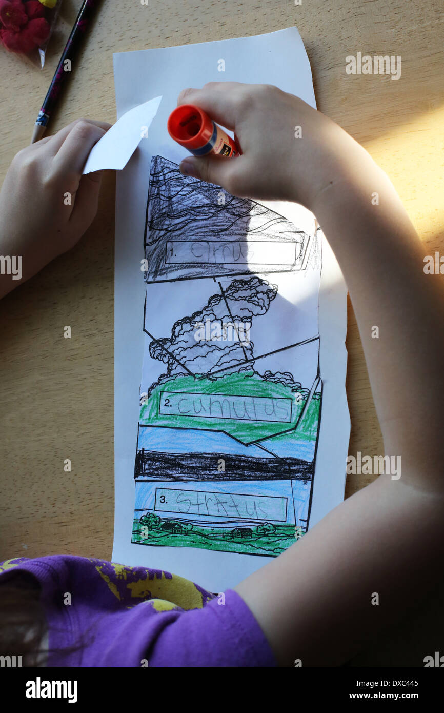 A young child doing homework on clouds Stock Photo - Alamy