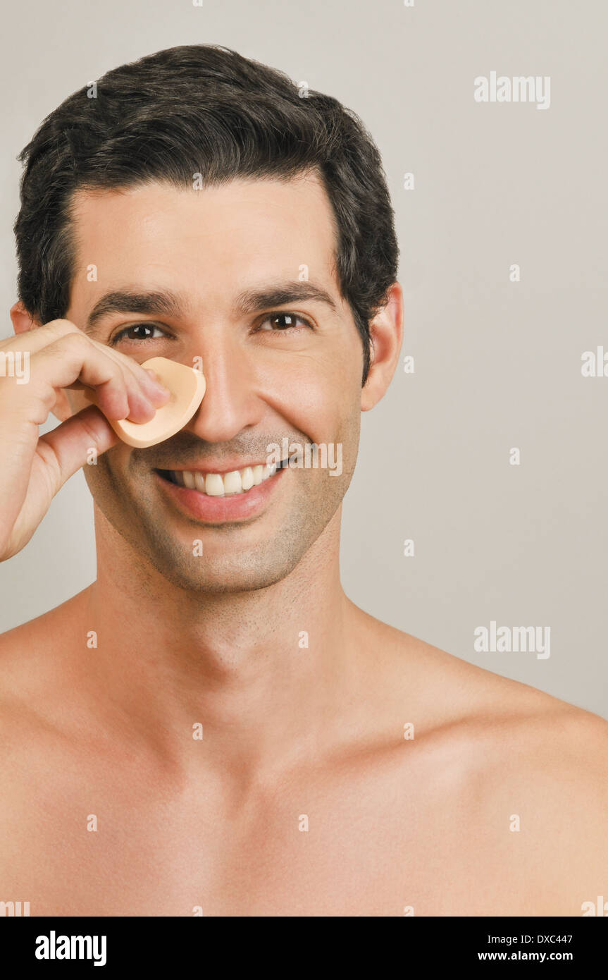 Young male adult blotting face with pad Stock Photo - Alamy