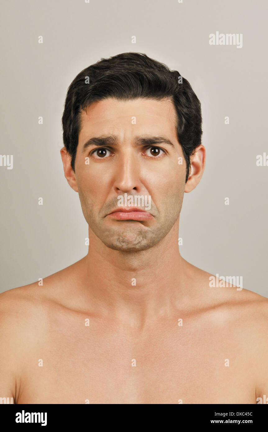 Young male adult face, upset expression Stock Photo - Alamy
