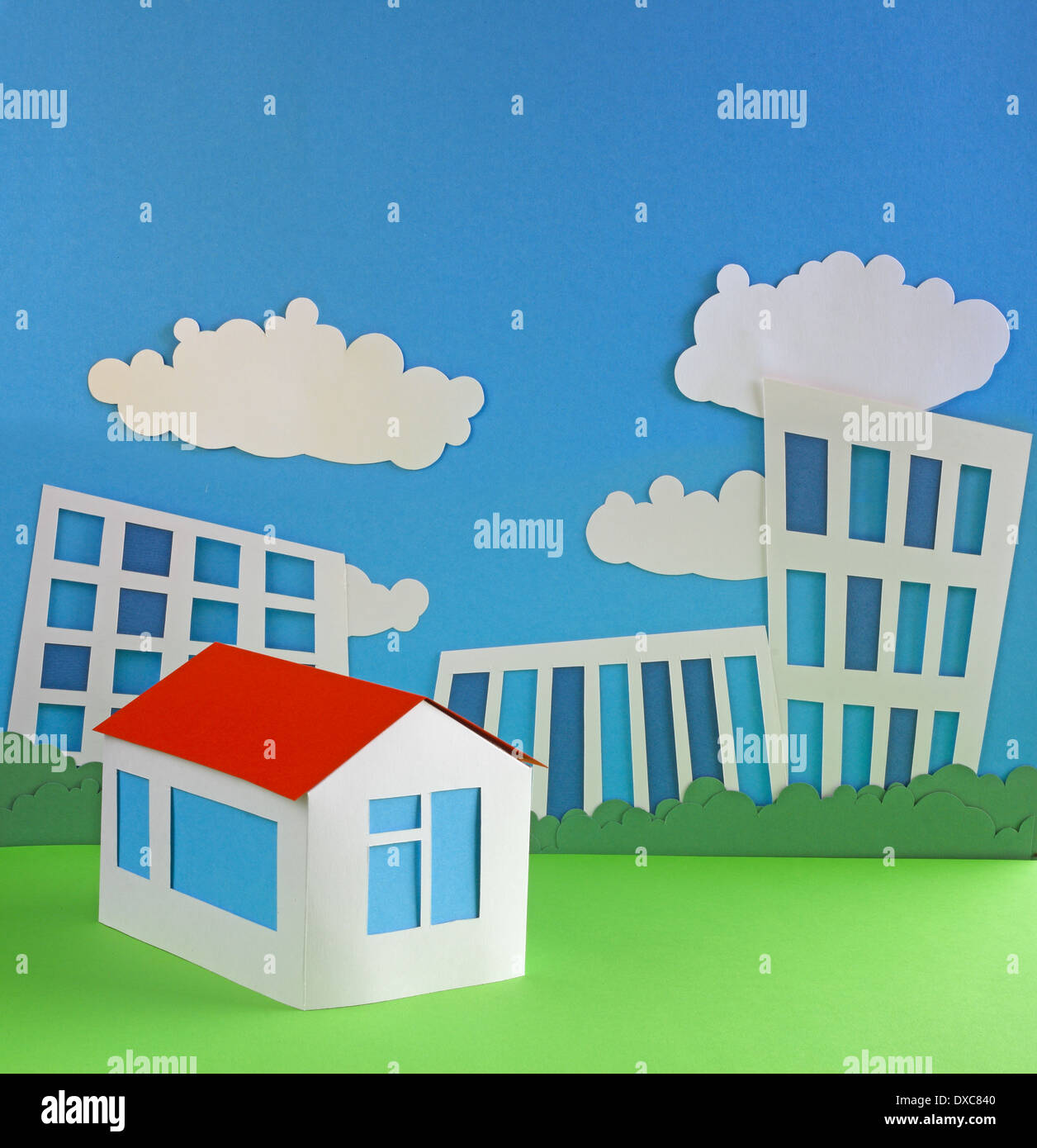 Paper cottage over city background real estate concept Stock Photo - Alamy