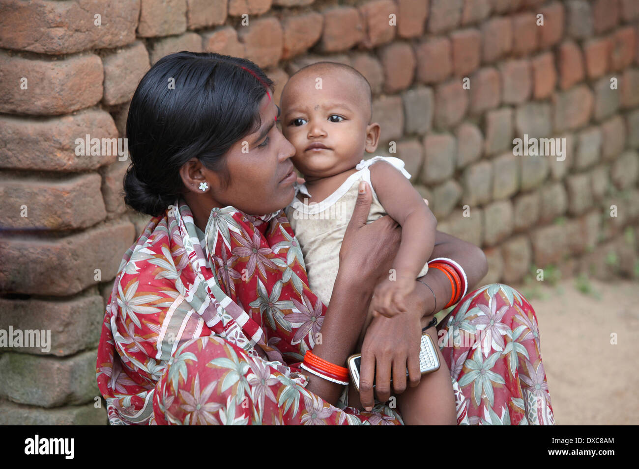 Tribal woman sitting with her baby. Santhal tribe, Soren clan ...