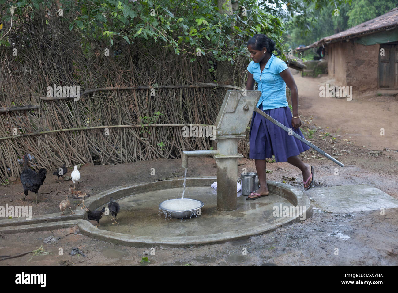 Tribal girl pumping water froma a handpump. Munda tribe. Bartoli ...