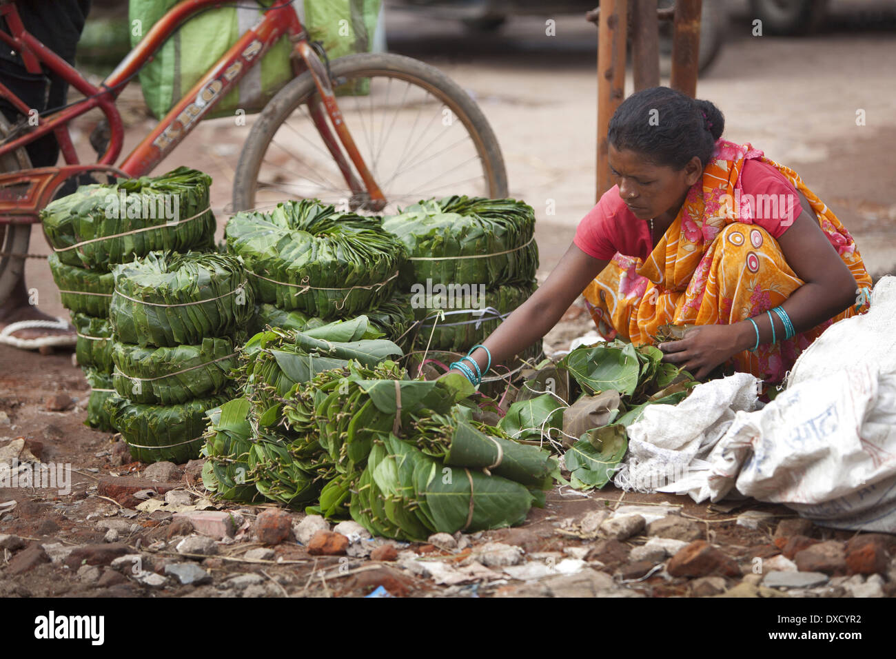Munda tribal woman selling leaf plates called patal made from jungle ...