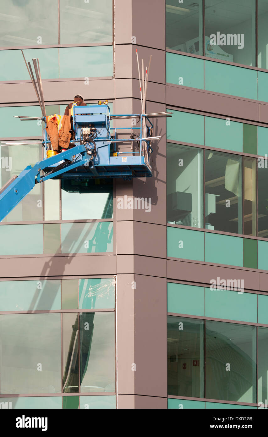 Office building construction worker installing window at Dartmouth ...