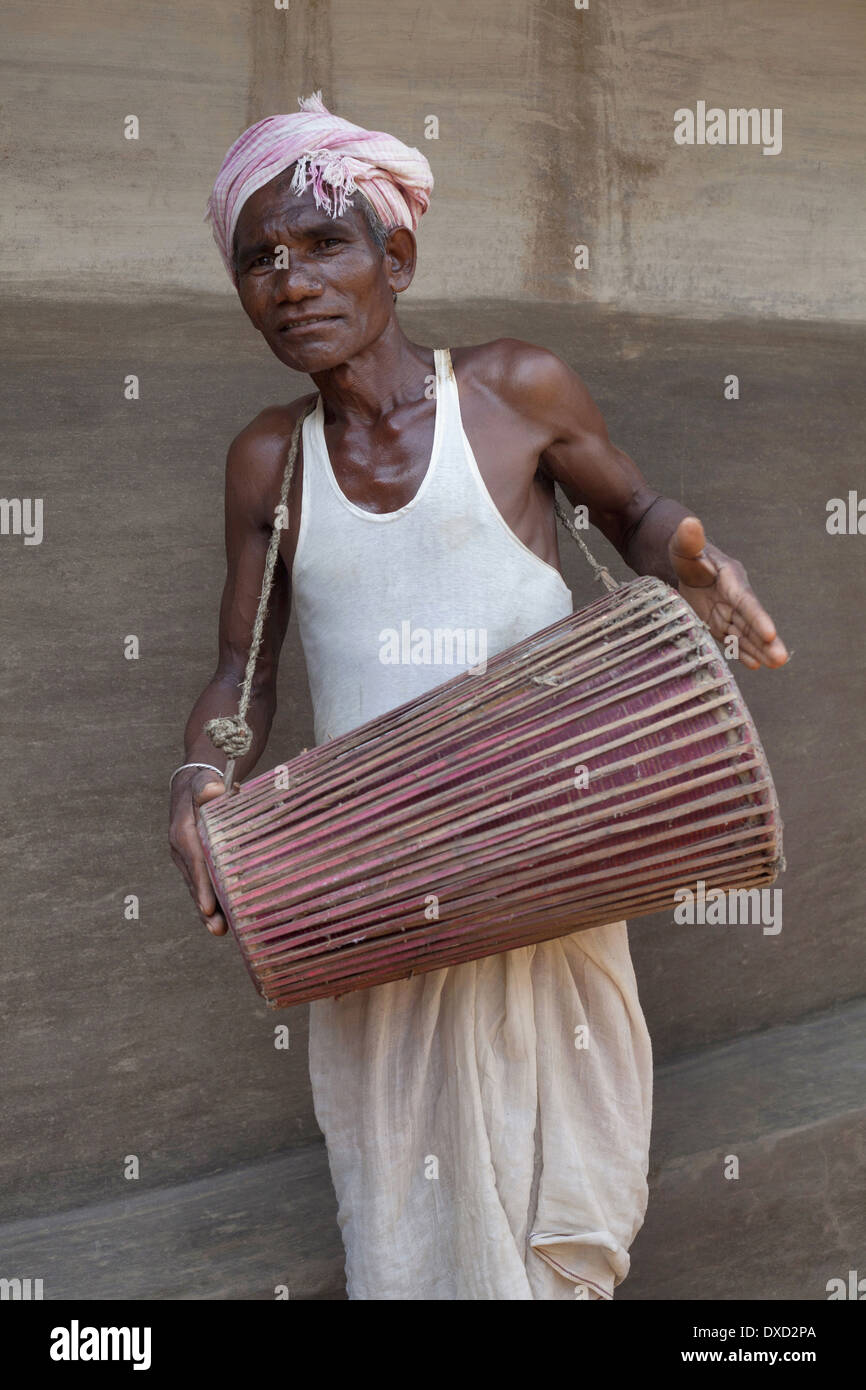 Santhal man playing Mandar drums made of earth with leather diaphragms ...