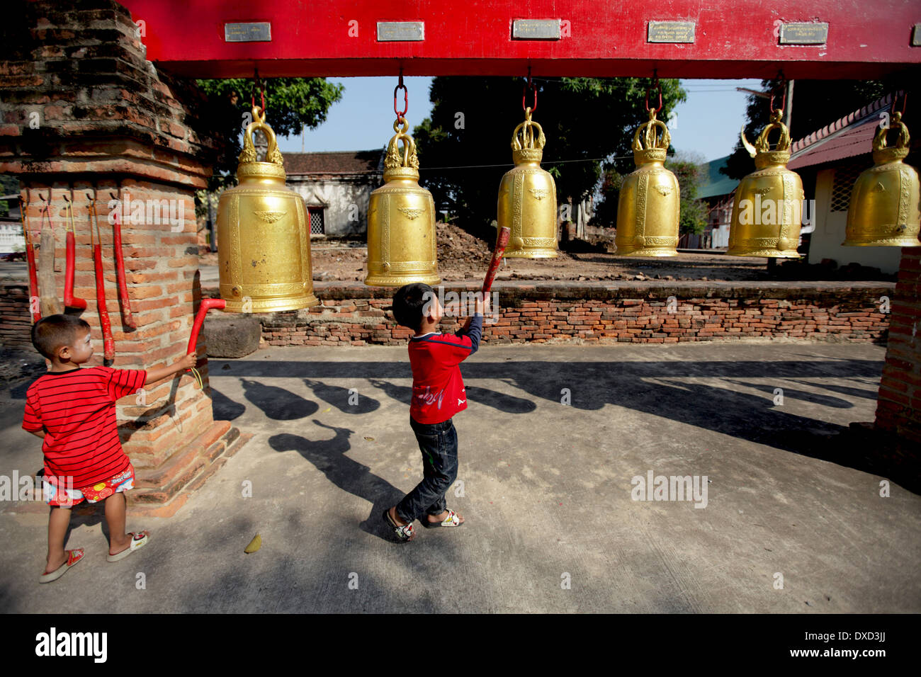 Children hit the bells at a temple in Chainat, Thailand Stock Photo - Alamy