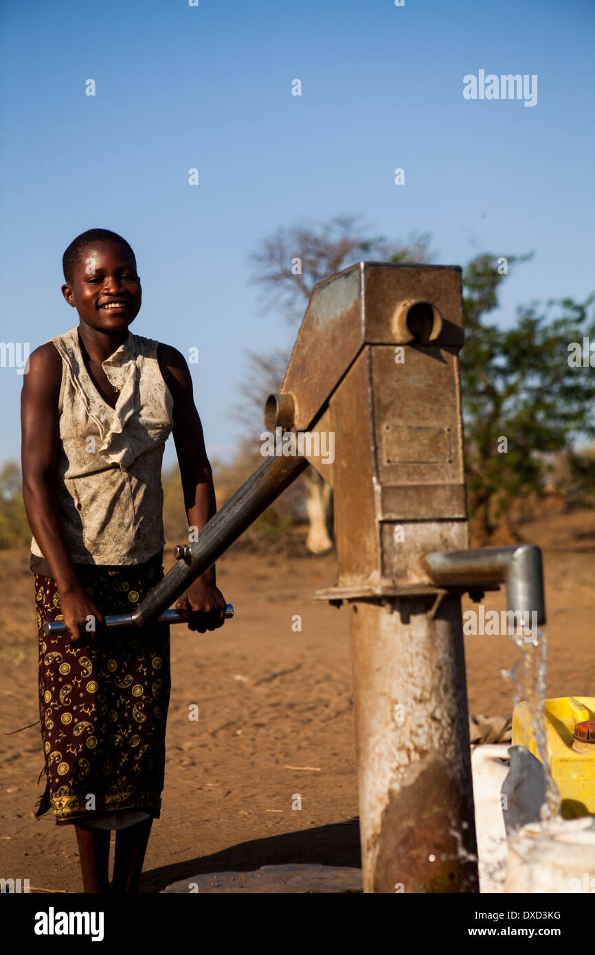 Africa child collecting water at a stand pipe Stock Photo - Alamy