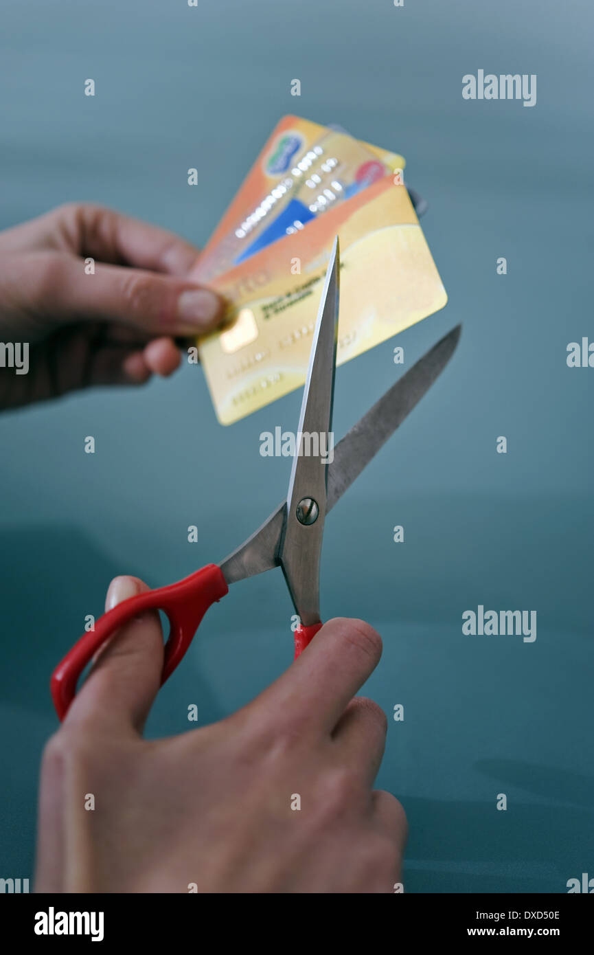 Hands cutting credit cards with scissors Stock Photo - Alamy