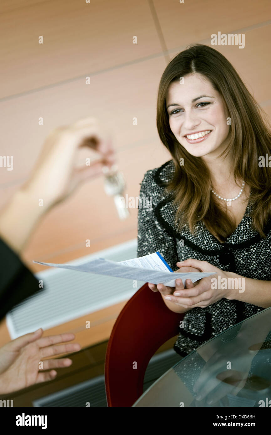 Young woman holding document, female hand holding keys Stock Photo - Alamy