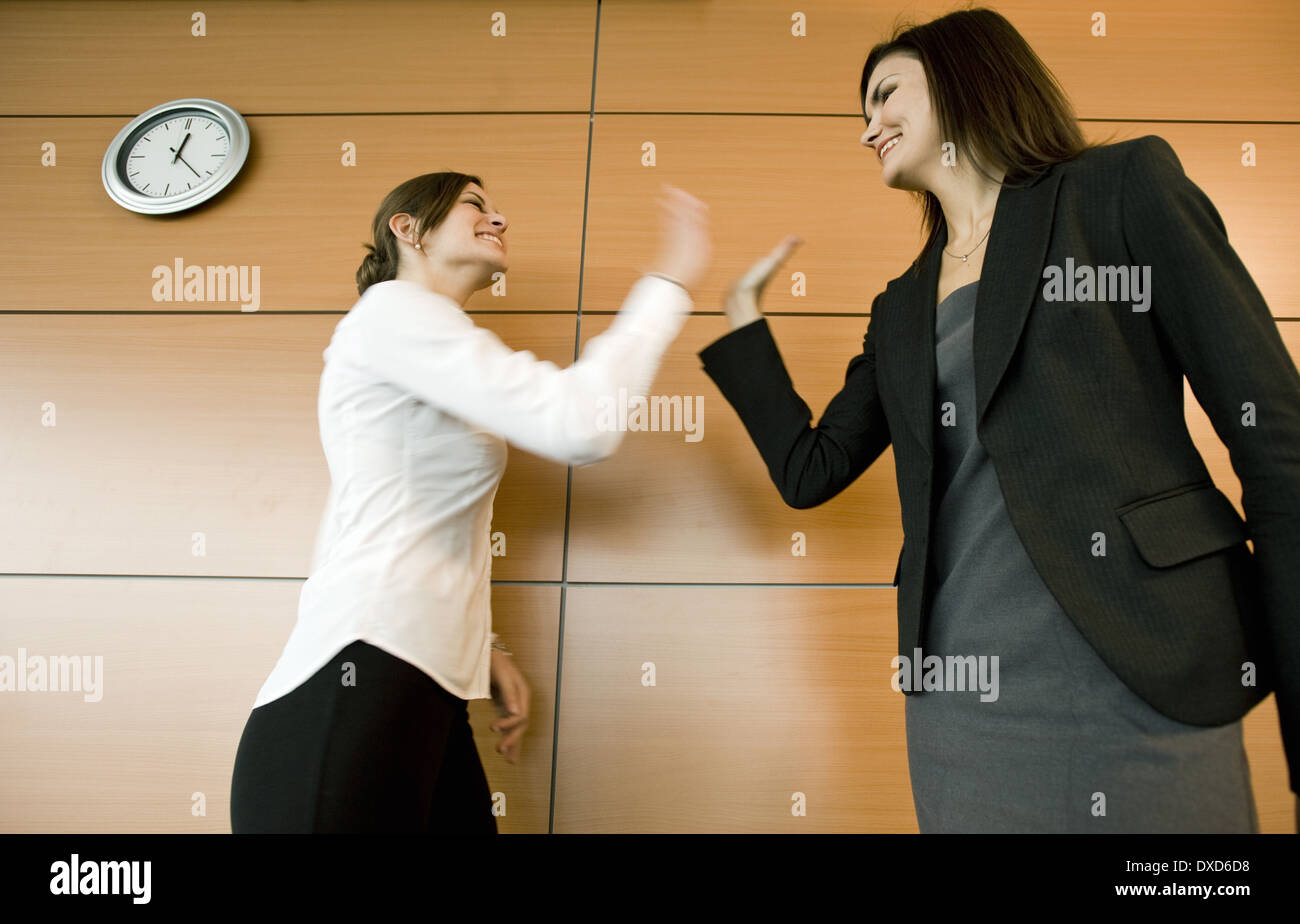 Businesswomen doing high five Stock Photo - Alamy