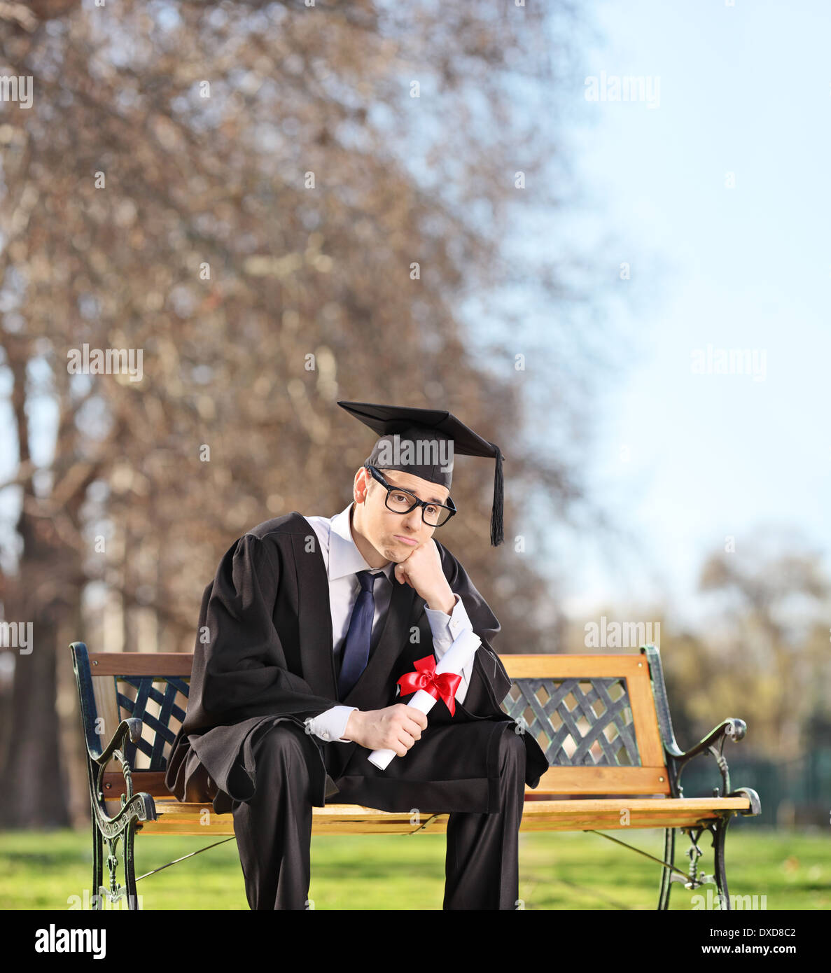 Young man graduation cap sitting hi-res stock photography and images ...