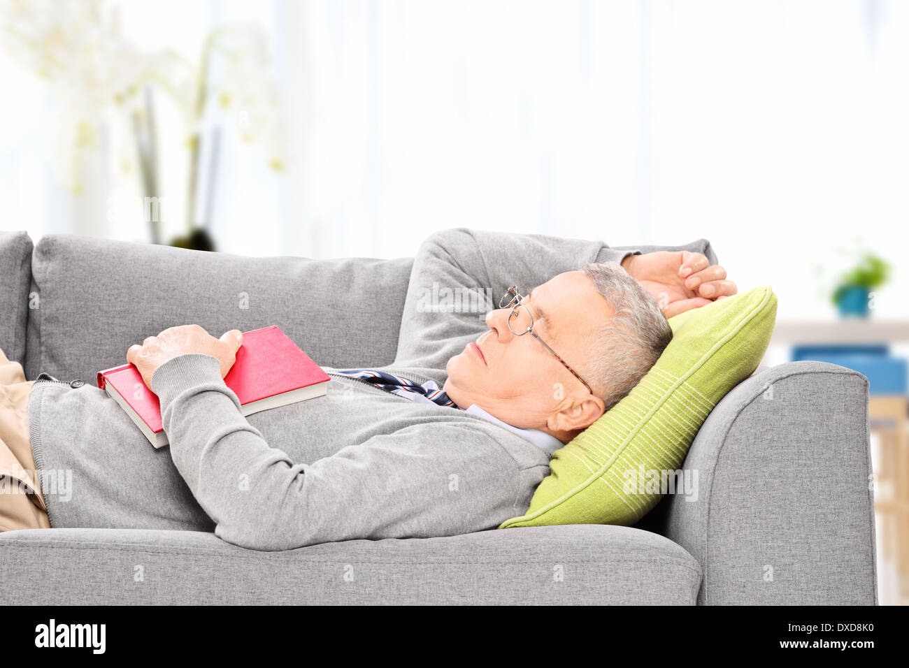 Old man sleeping on sofa hi-res stock photography and images - Alamy