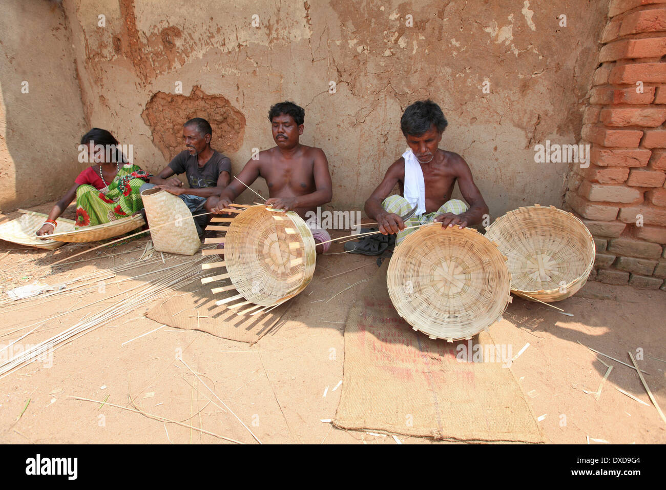 Tribal artisans making baskets with dry bamboo strips. Uraov tribe ...