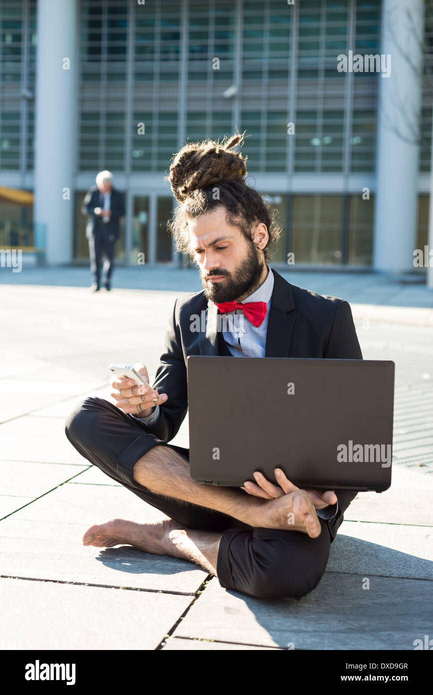 Stylish elegant dreadlocks businessman using notebook in business ...
