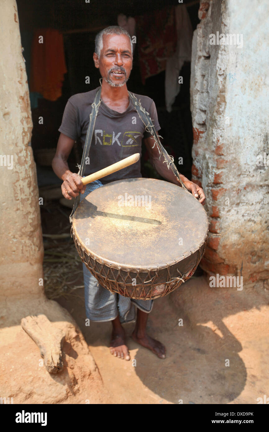 Tribal musician playing a traditional musical instrument, Nagada. oraon ...