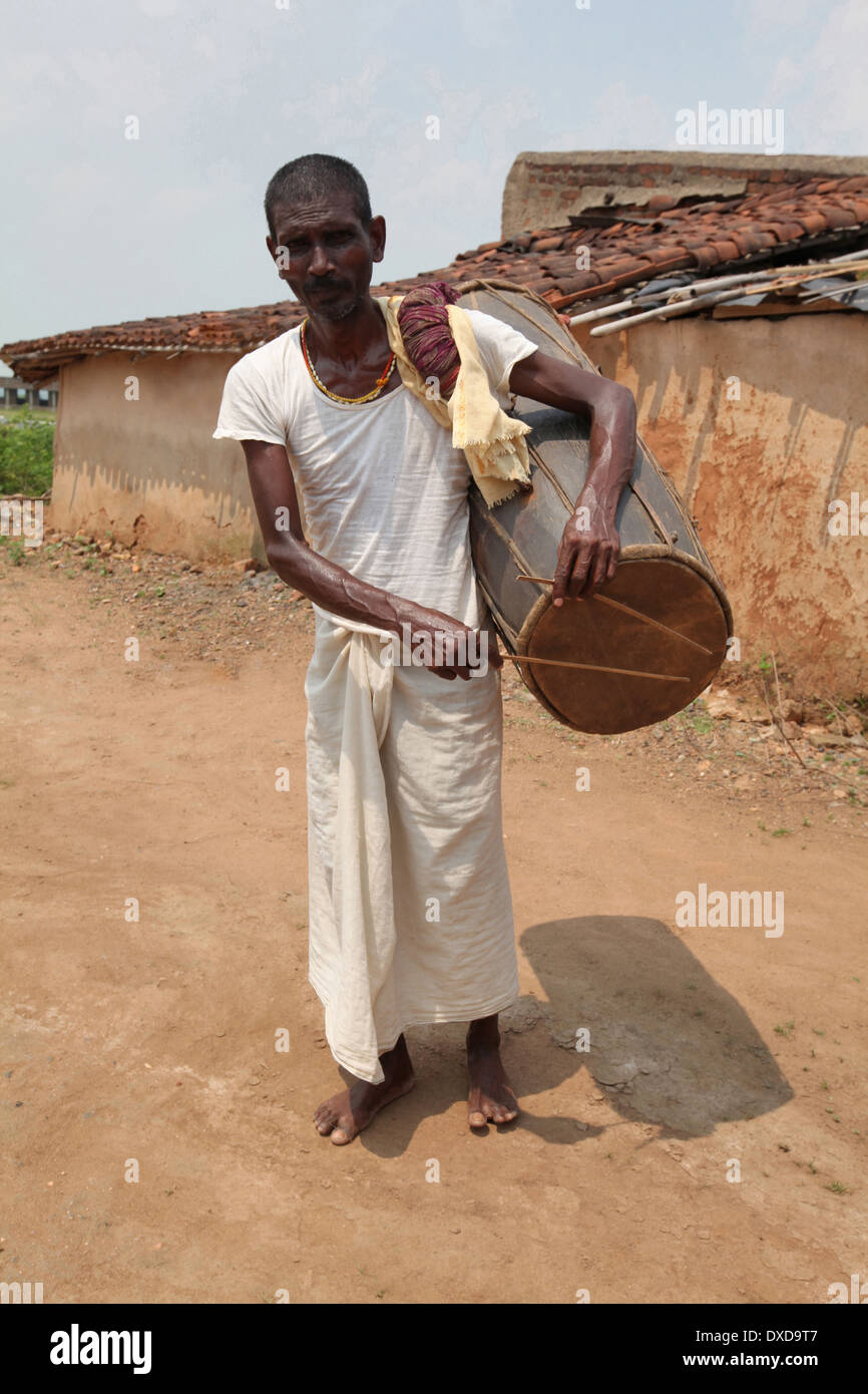 Tribal musician playing a traditional musical instrument, Dholak. Uraov ...