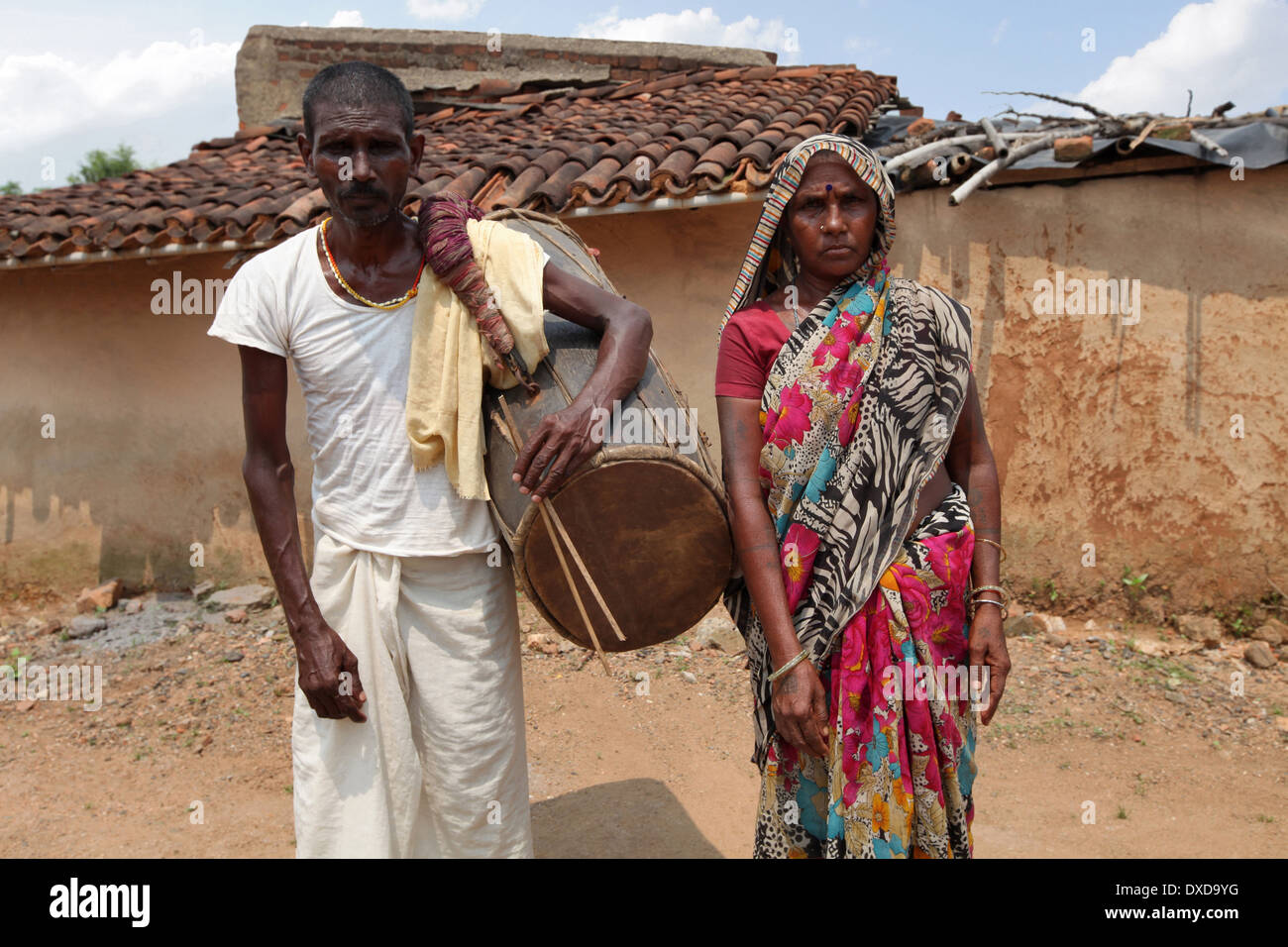 Uraov tribal musician standing with his wife with traditional musical ...