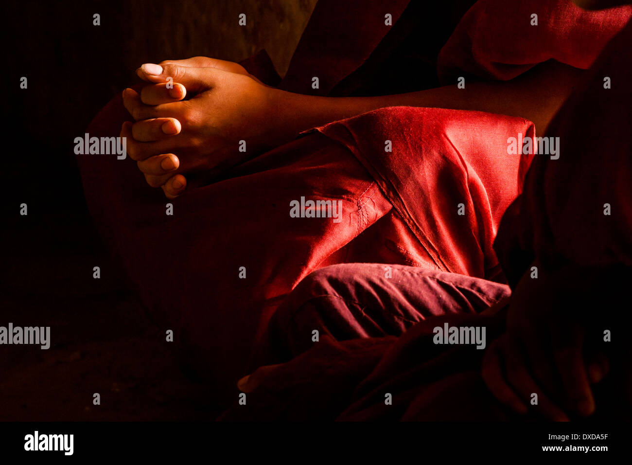 A monk hands are illuminated by a shaft of sunlight Stock Photo - Alamy