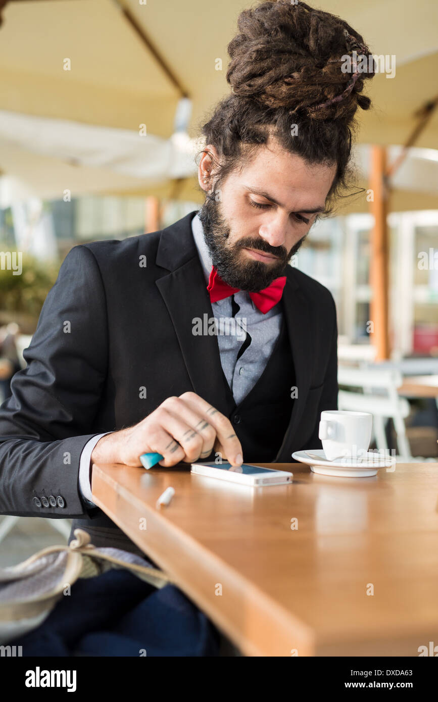 Stylish elegant dreadlocks businessman at the bar in business landscape ...
