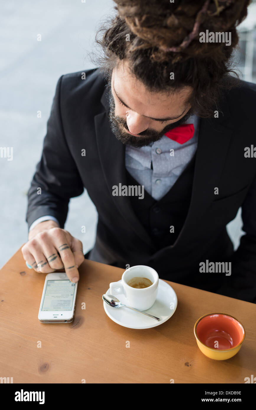 Stylish elegant dreadlocks businessman at the bar in business landscape ...