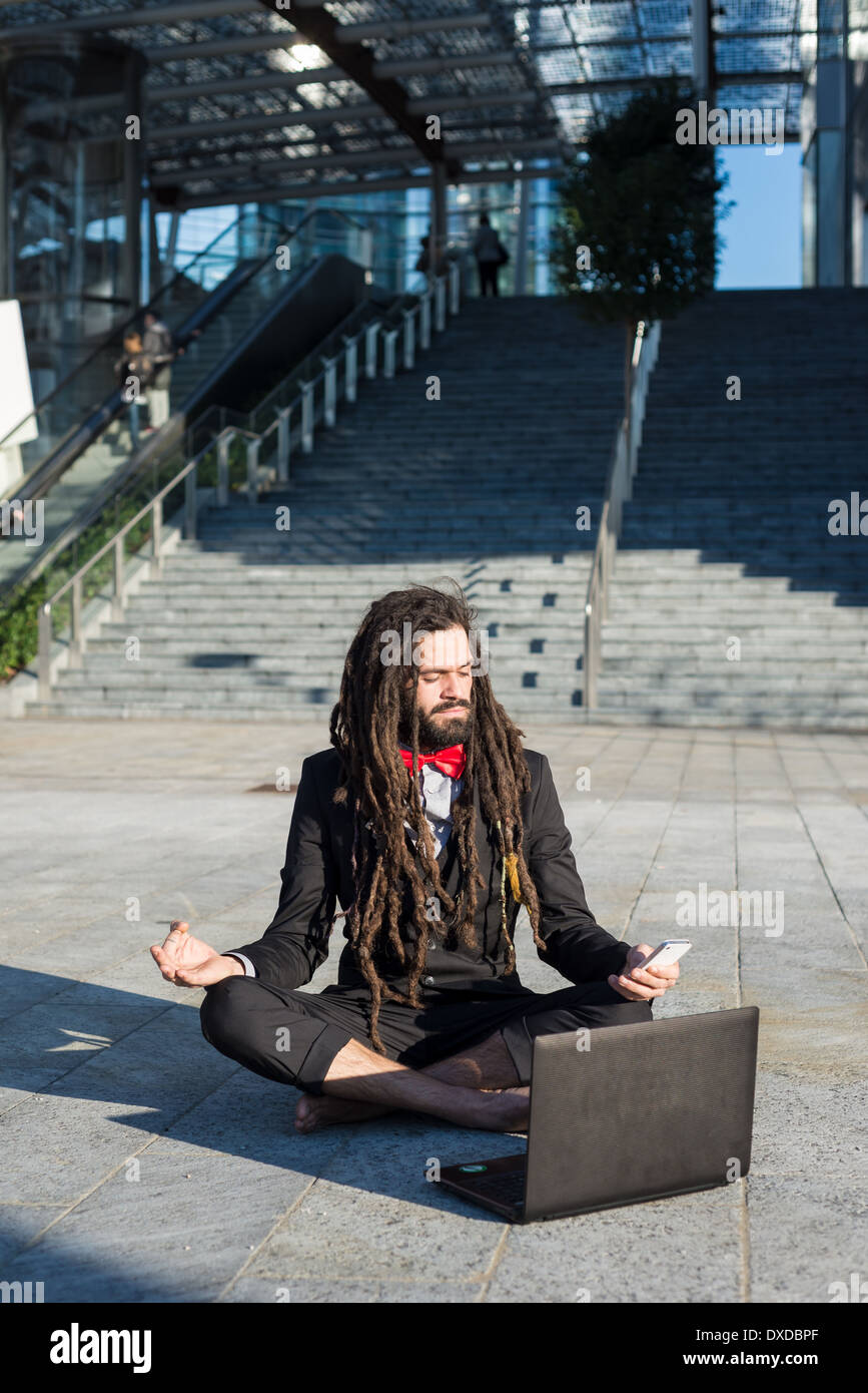 Stylish elegant dreadlocks businessman using notebook in business ...