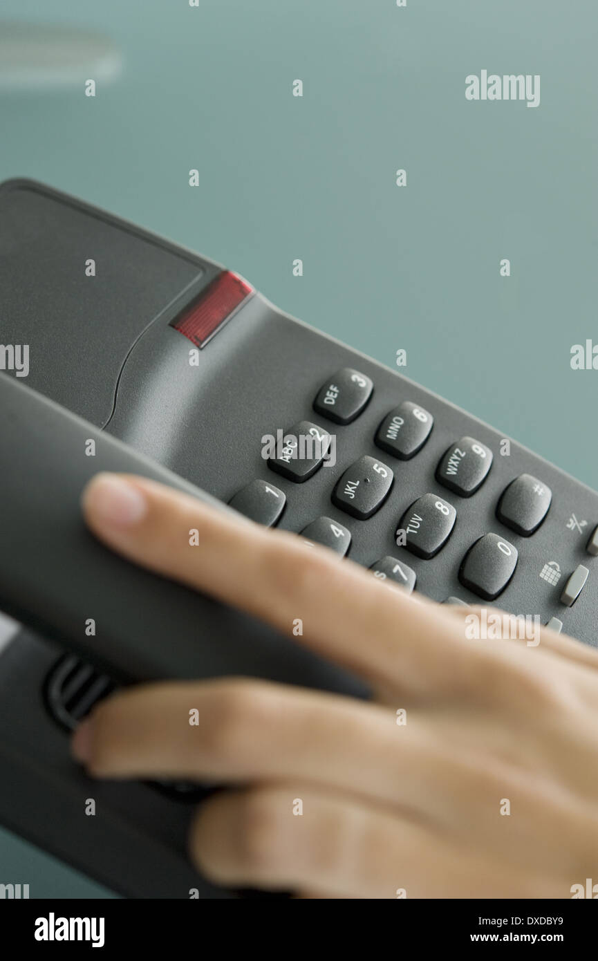 Closeup of woman's hand on telephone Stock Photo - Alamy
