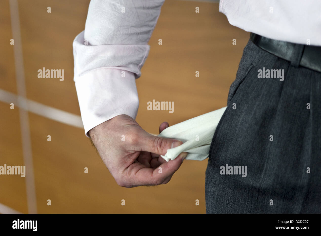 Businessman pulling out empty pocket Stock Photo - Alamy