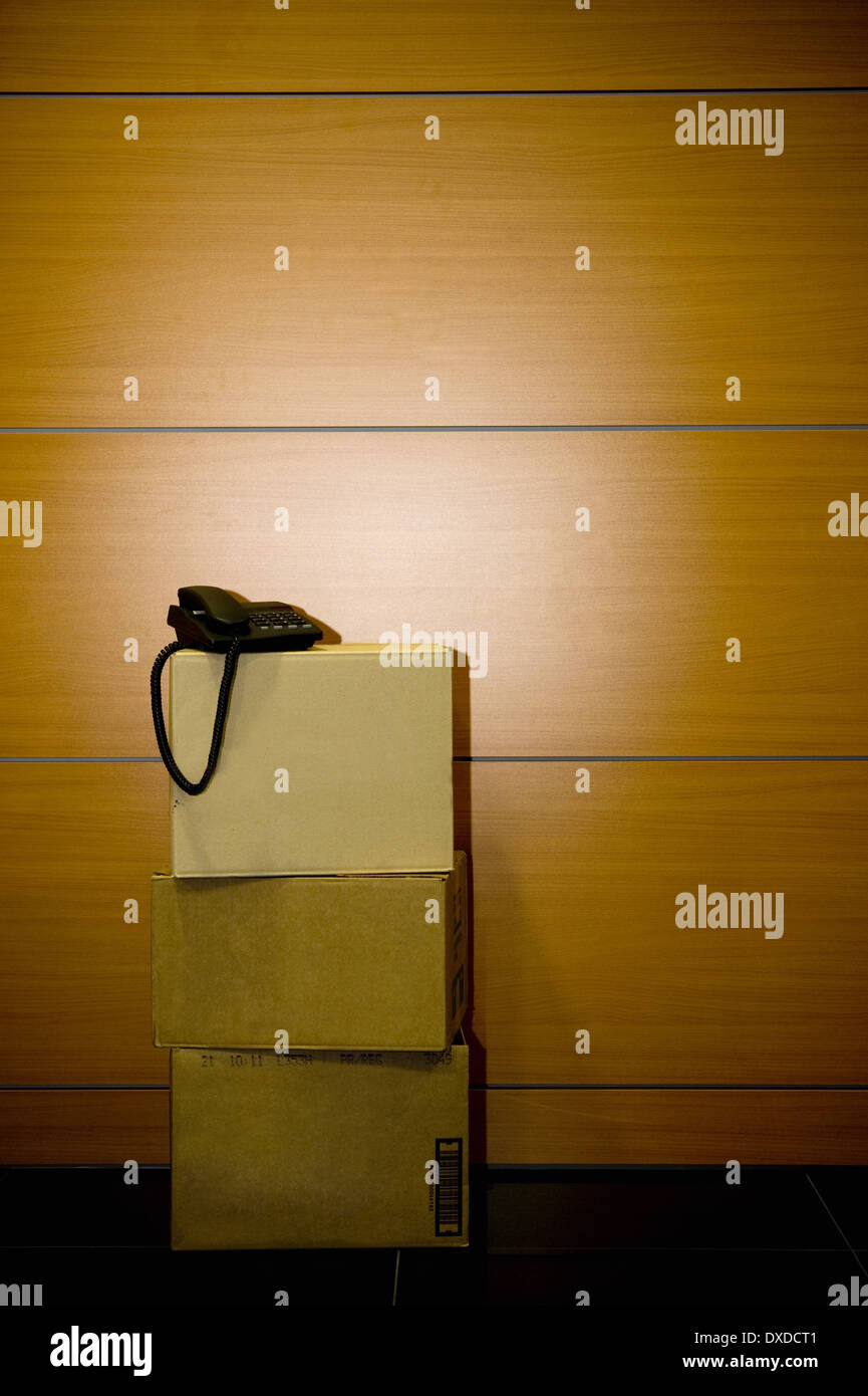 Telephone on cardboard boxes in office Stock Photo - Alamy