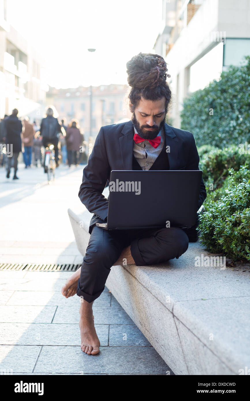 Stylish elegant dreadlocks businessman using notebook in business ...