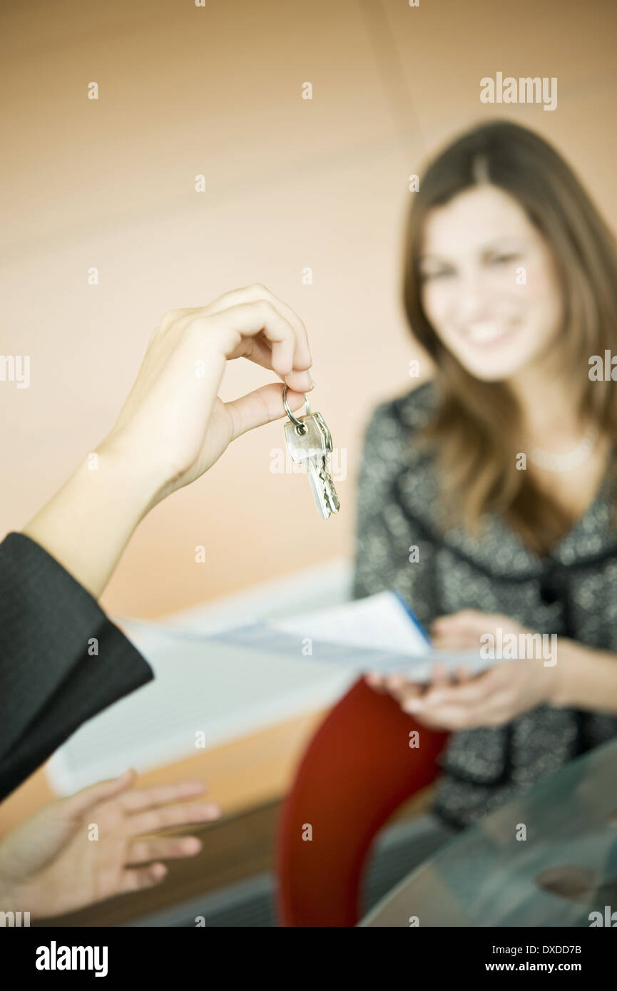 Young woman holding document, female hand holding keys Stock Photo - Alamy
