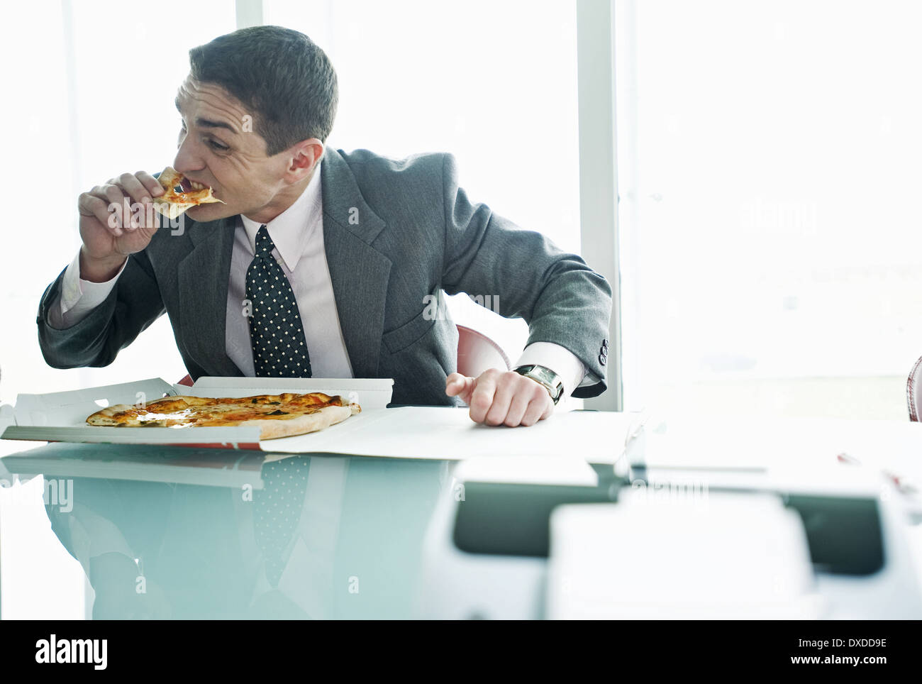 Businessman eating pizza desk hi-res stock photography and images - Alamy