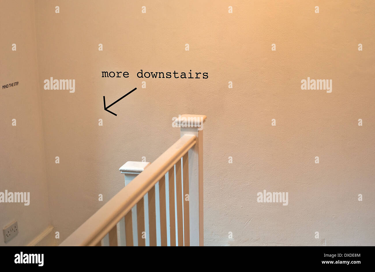 More downstairs sign with arrow Stock Photo - Alamy