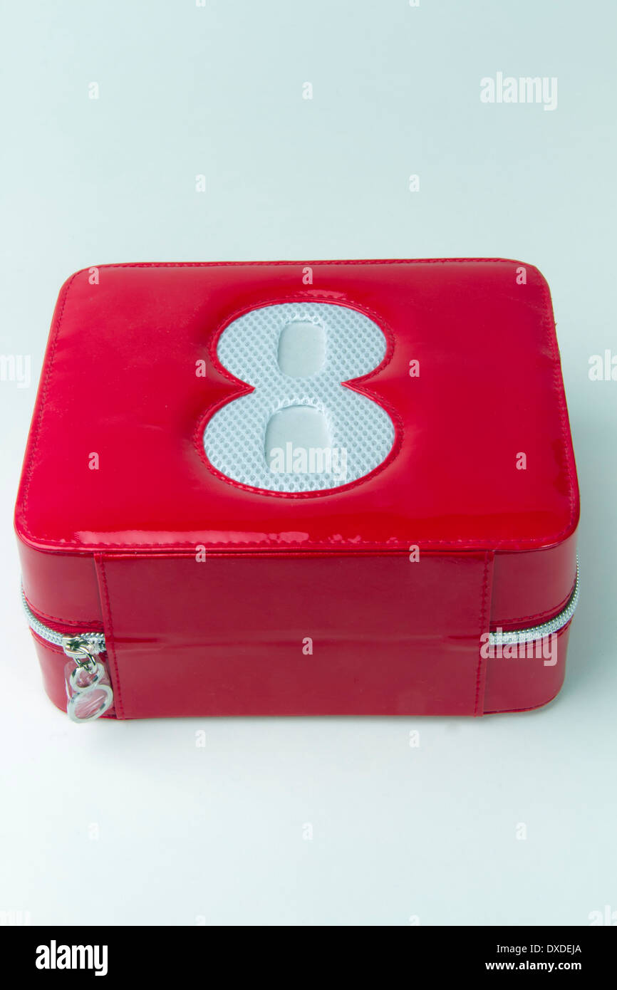 Red plastic zipped make up box with the figure eight etched in its lid ...