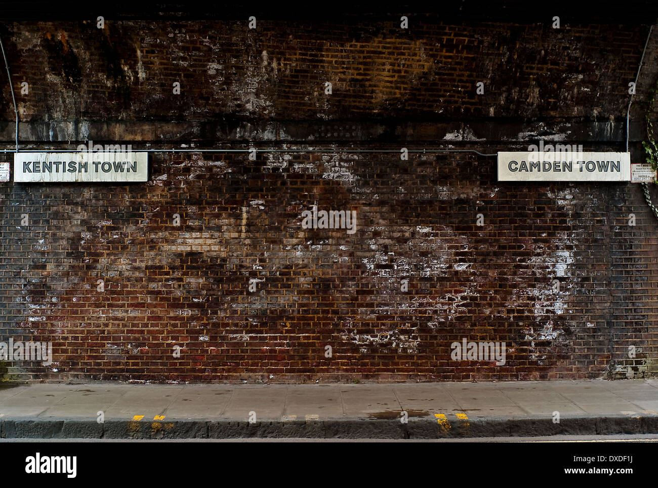 Kentish town and camden direction signs under victorian railway bridge ...