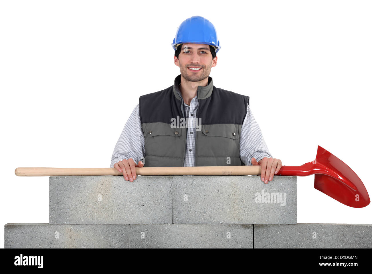 Mason with a shovel Stock Photo - Alamy