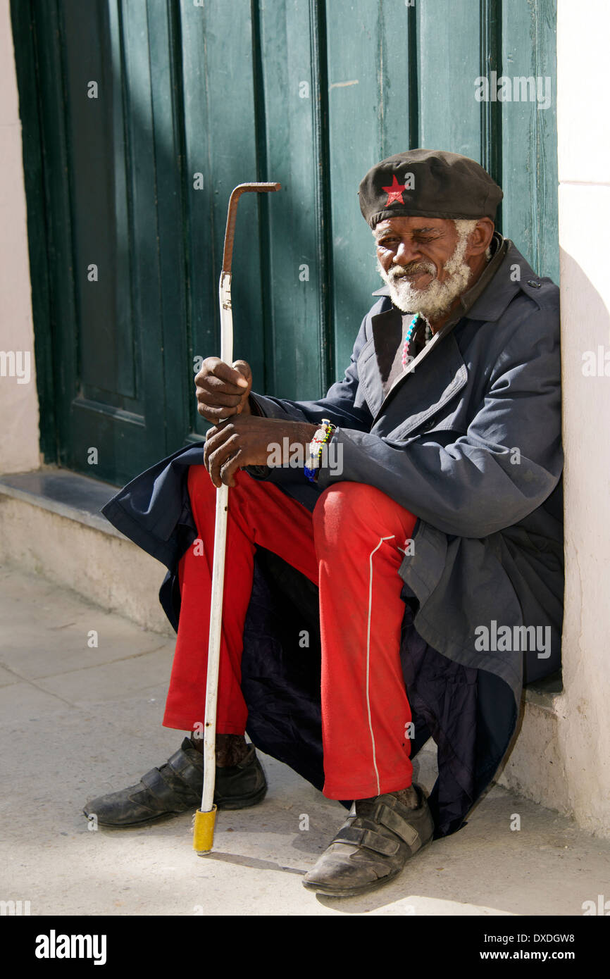 Old man seated in doorway and wearing revolutionary cap Old Havana Cuba ...