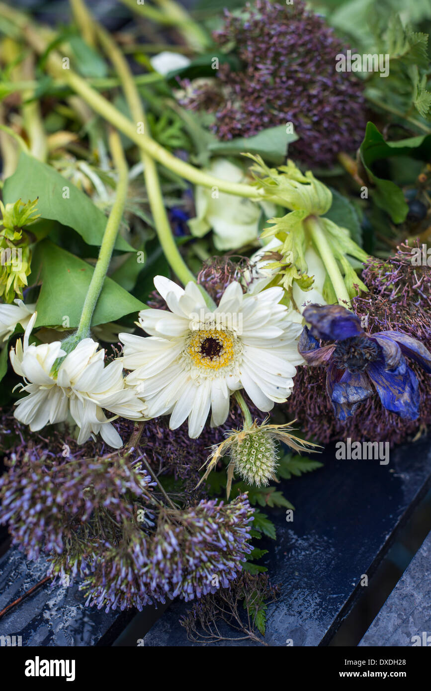 Pile of old flowers on a garden table Stock Photo - Alamy