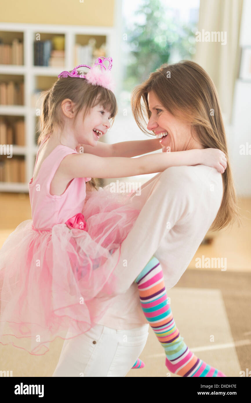 Mother holding daughter (4-5) wearing tutu Stock Photo - Alamy