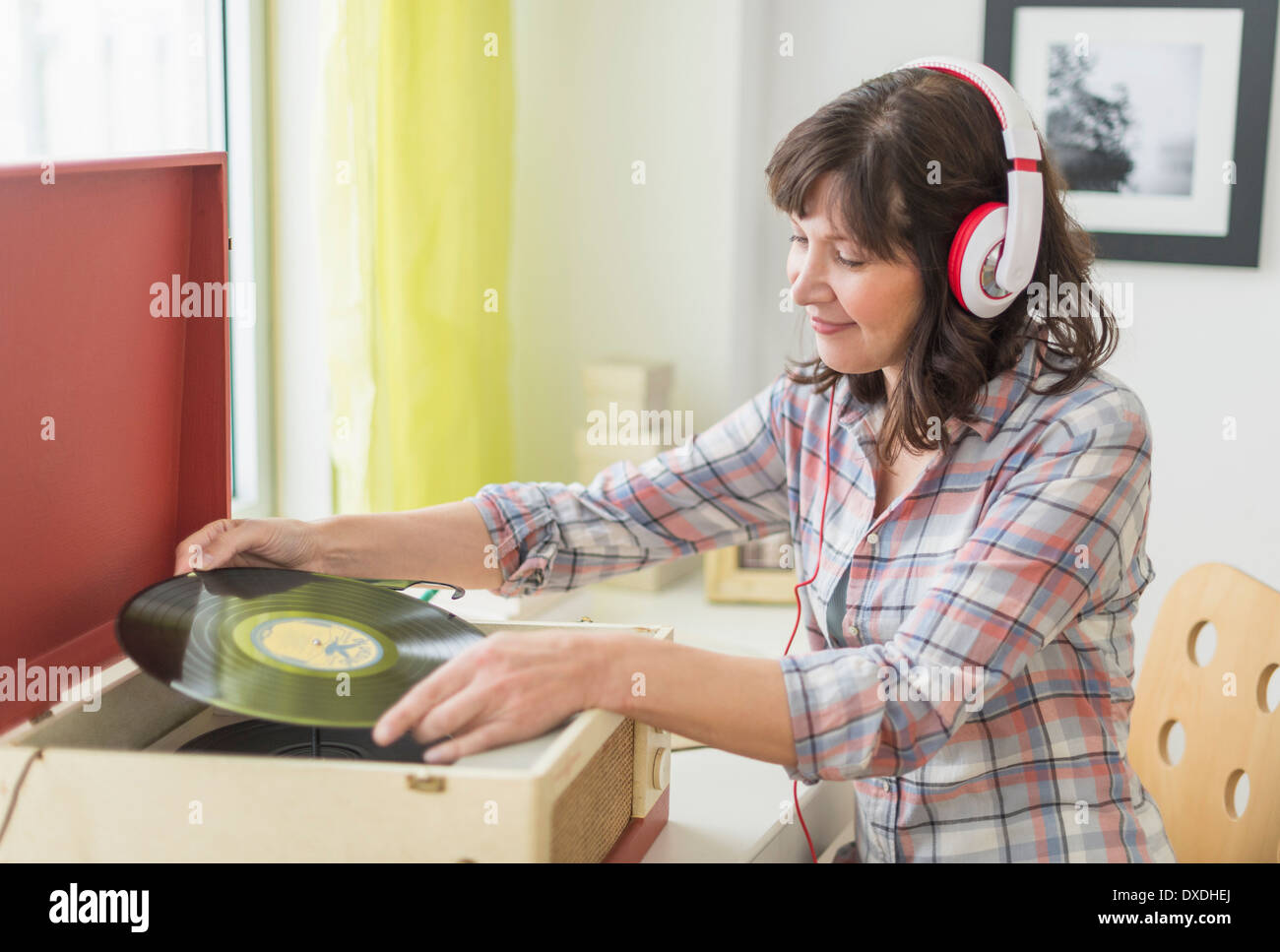 Woman listening to music on antique record player Stock Photo - Alamy