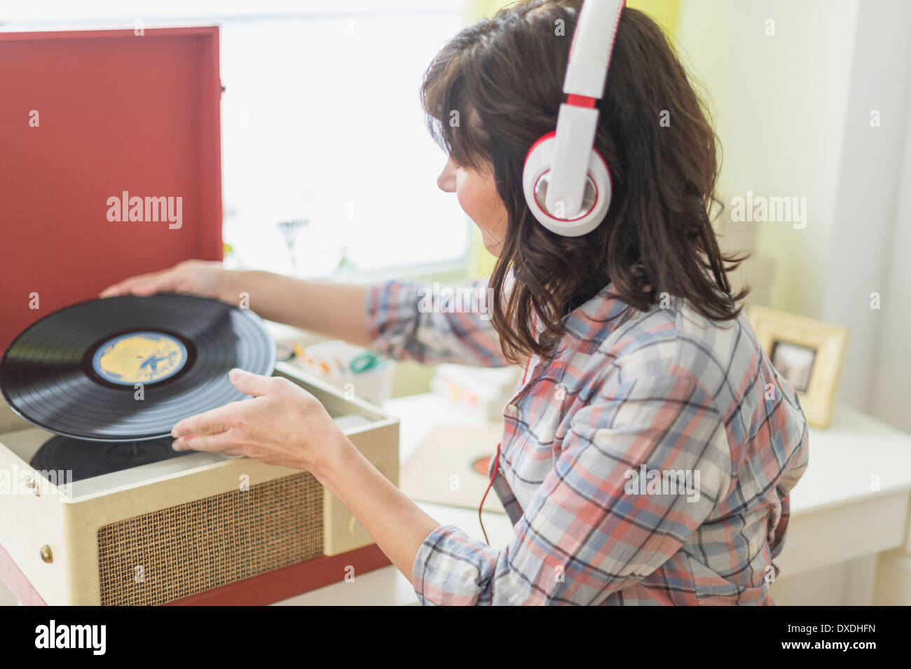 Woman listening to music on antique record player Stock Photo - Alamy