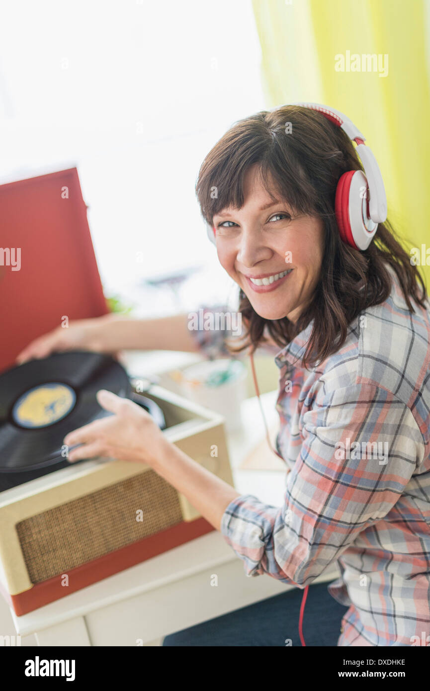 Woman listening to music on antique record player Stock Photo - Alamy