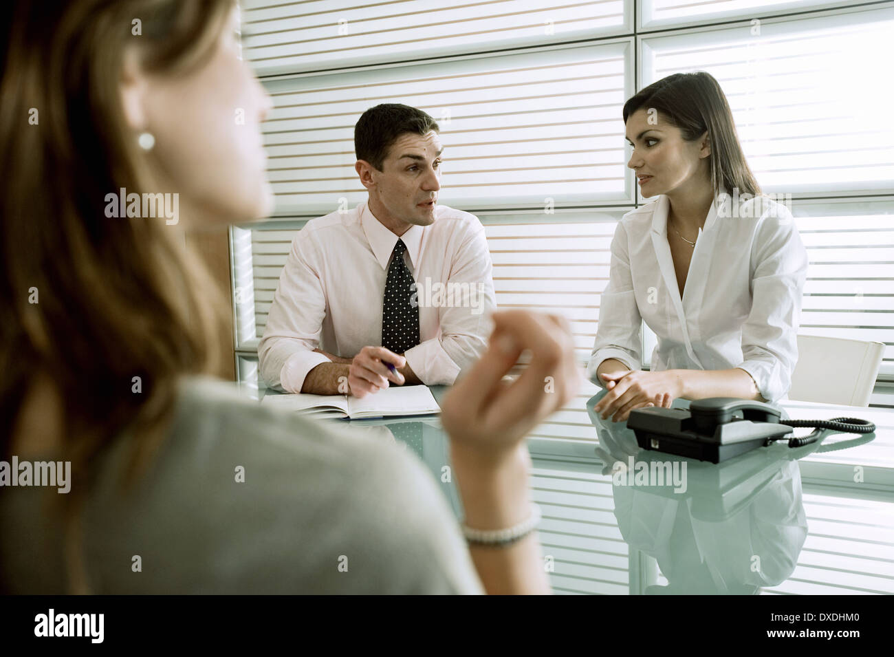 Business people interviewing professional woman Stock Photo - Alamy