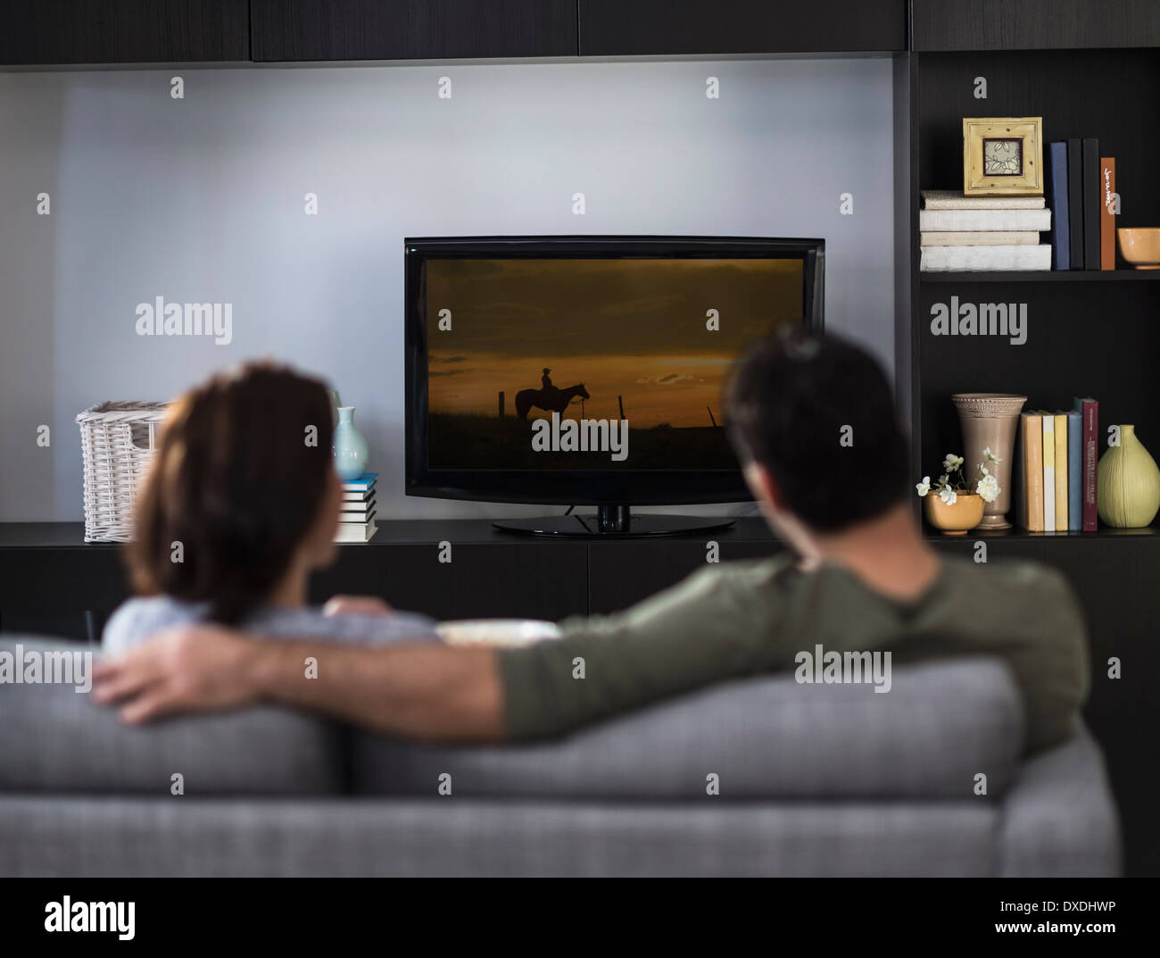 Rear view of couple watching tv Stock Photo - Alamy