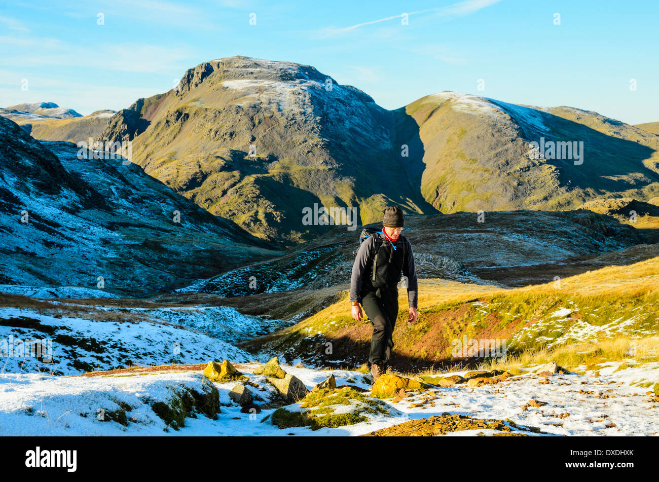 Walker climbing to Esk Hause in the Lake District with Great Gable ...